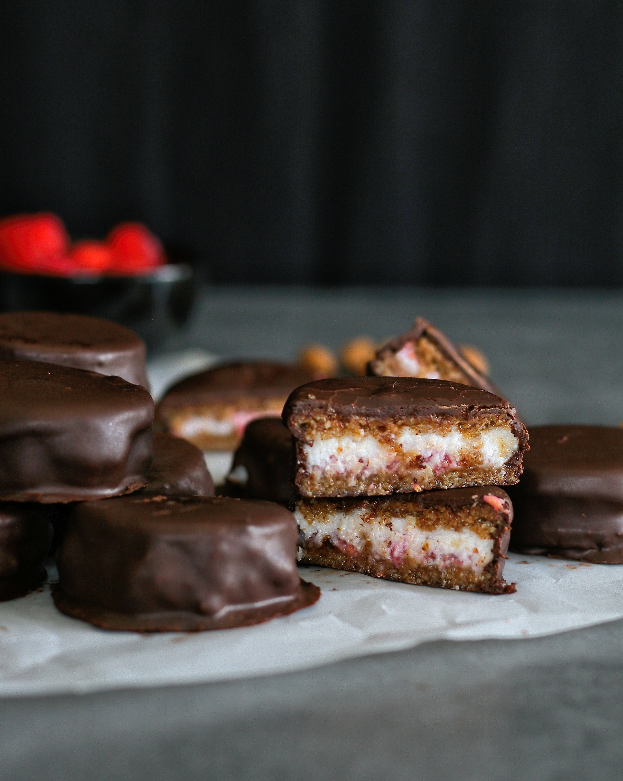 Chocolate coated raw cookies with raspberry and coconut filling ...
